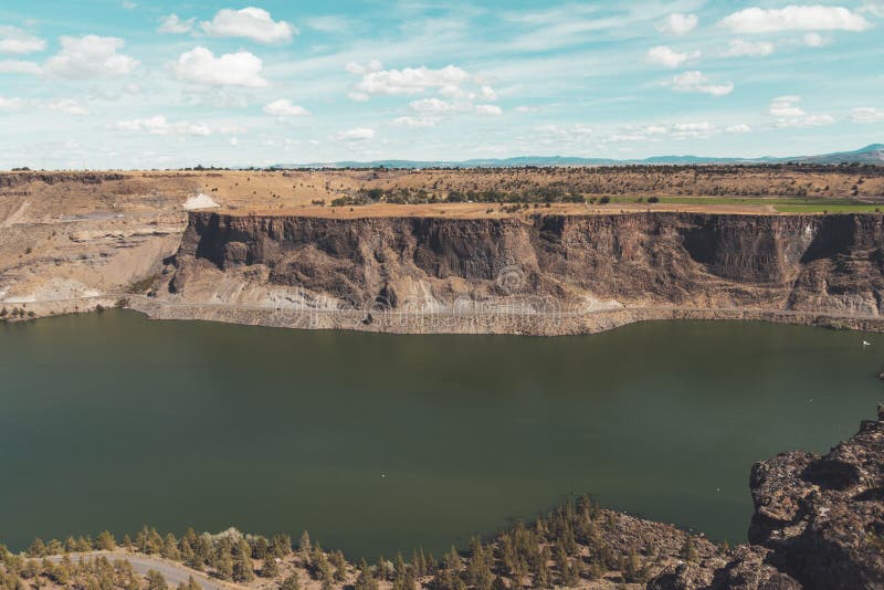 Landscape of a River Surrounded by Cliffs Covered in Greenery Under a ...