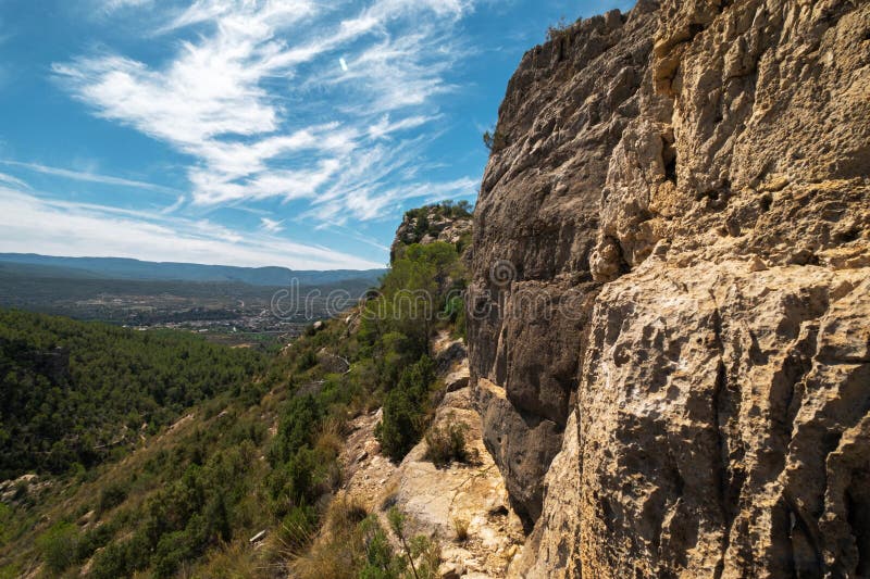Landscape of Rocky Cliffside Path Overlooking Lush Green Valley with ...