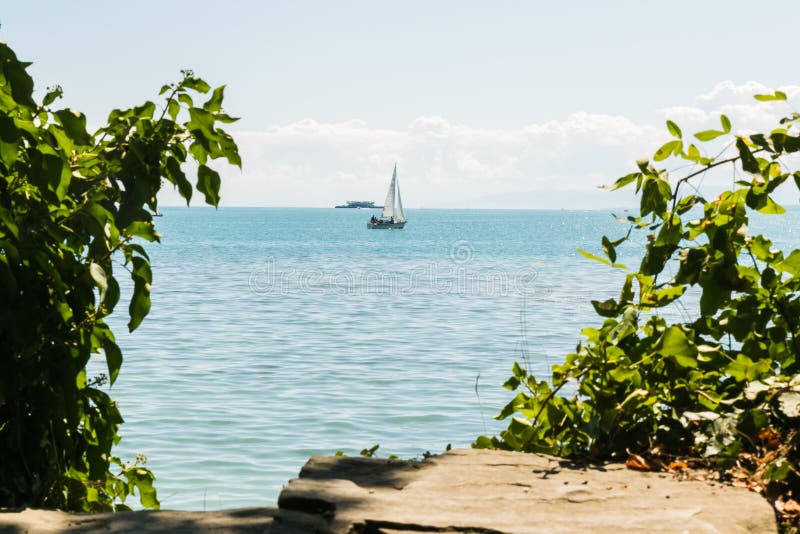 Landscape with Sailboat Seen from the Coast Stock Photo - Image of ...