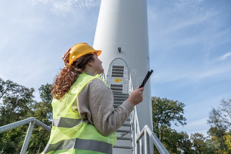 Landscape Shot of a Female Engineer Standing in Front of a Windmill ...
