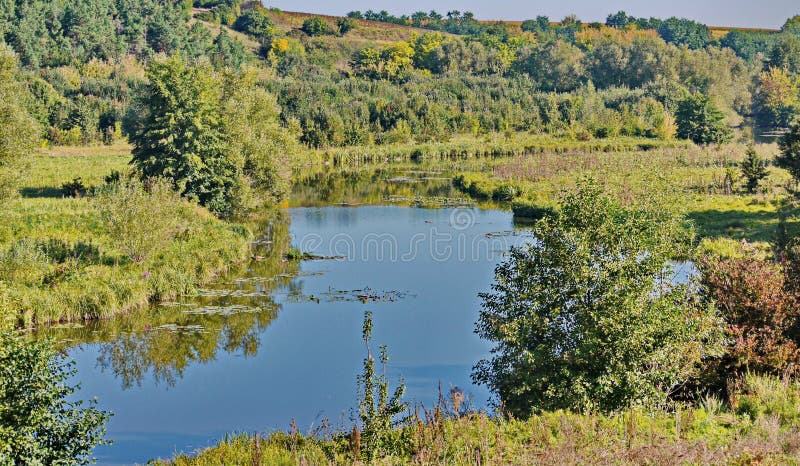 Landscape with a Small Blue River and Greenery on Both Sides of the ...