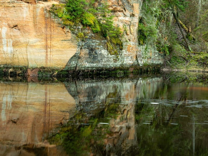 A Landscape with a Steep River and Caves on a Sandstone Cliff Stock ...