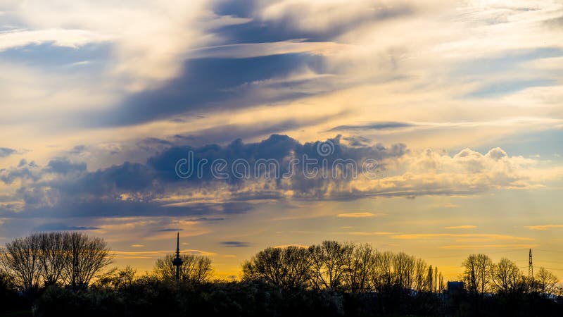 Ominous Clouds in Light Evening Sky Over Landscape. Stock Photo - Image ...