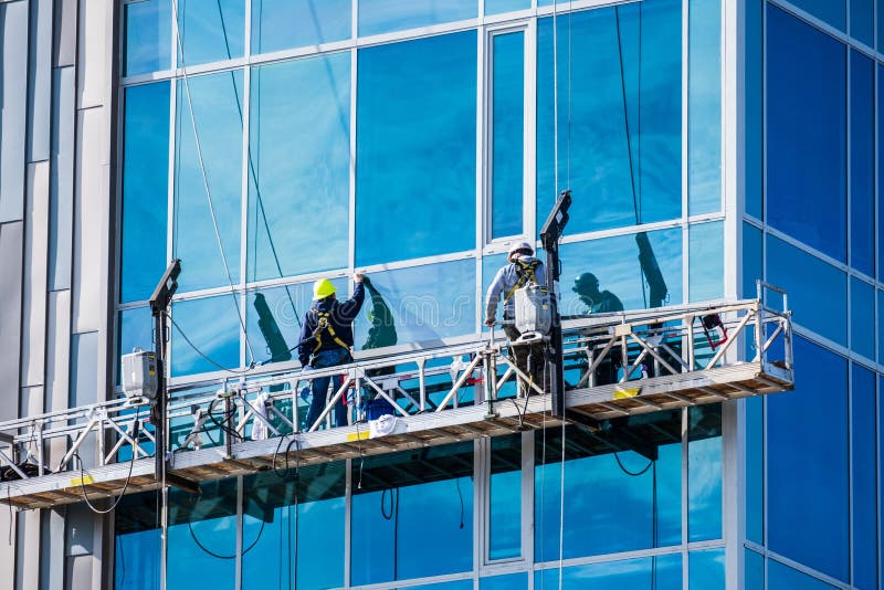 A Landscape View of Construction Workers High in the Sky Doing Repairs ...