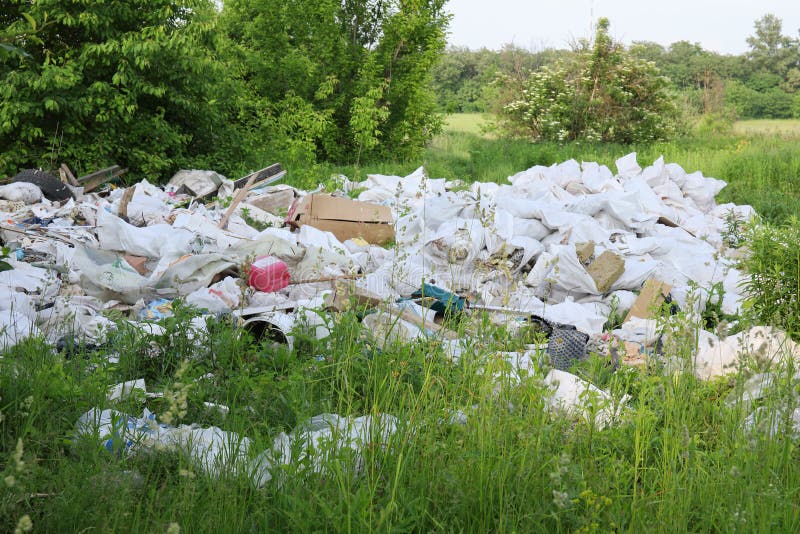 Landscape View on a Green Forest and Grass with Huge Garbage Dump ...