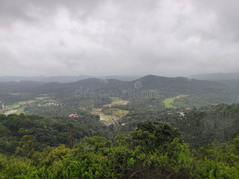 A Landscape View of Green Hills with Cloudy Sky on the Background in ...