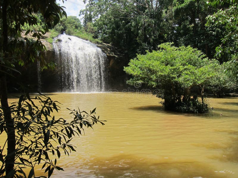 Landscape of a Waterfall Cascading Over a Brown and Muddy River ...