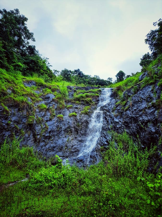 Landscape with Waterfall through the Rocks,greenery Stock Photo - Image ...
