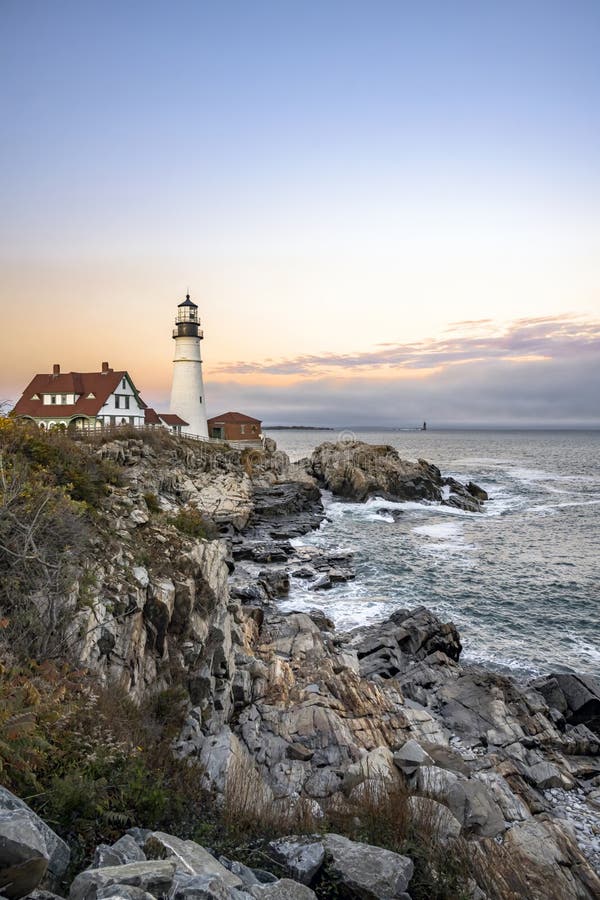 Landscape with a Wave-washed Operating Lighthouse on a Rocky Shore of ...