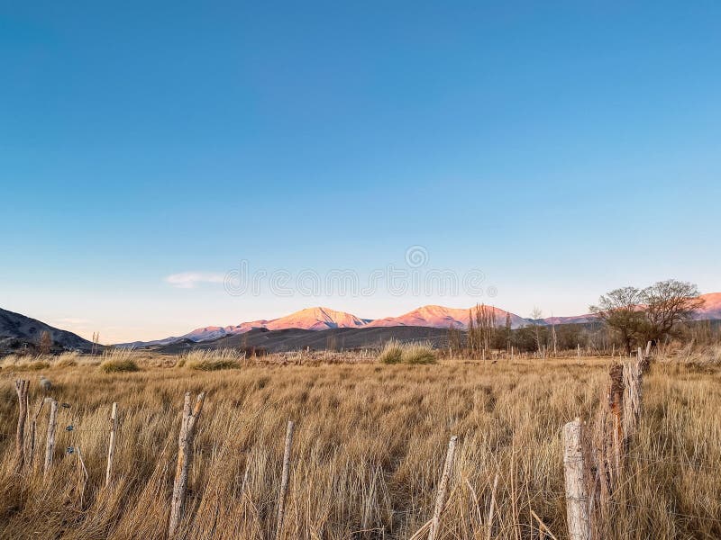 Landscape of Wide Fields Full of Dry Grass with Mountain Ranges on the ...