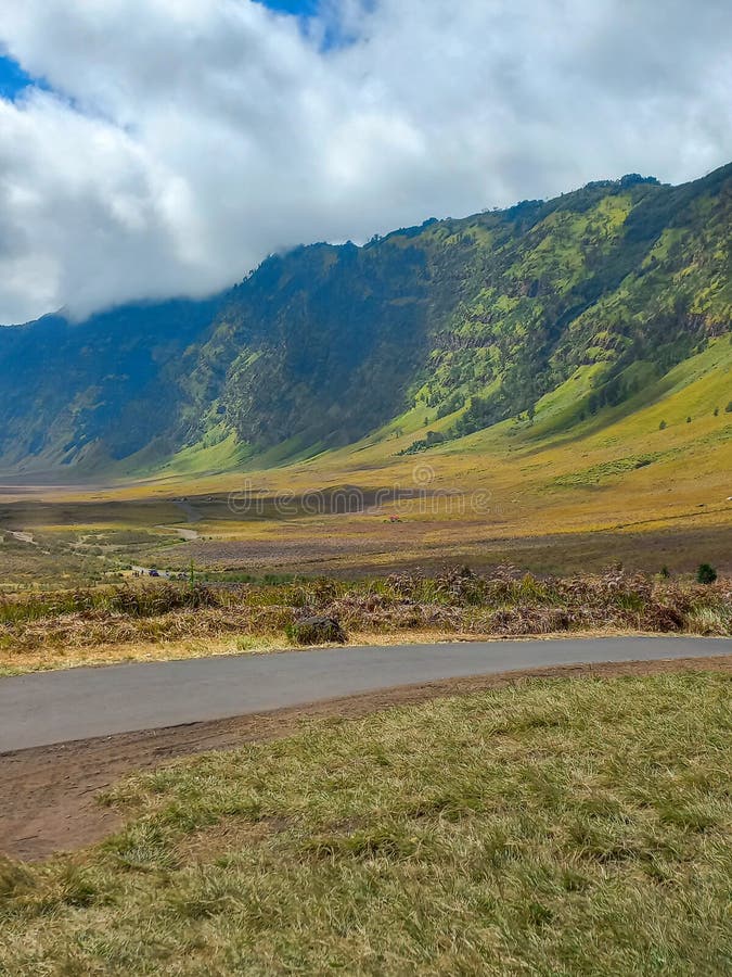 Landscape of a Wide Valley Surrounded by Towering Mountains Stock Image ...