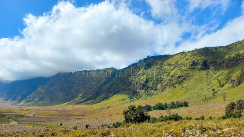 Landscape of a Wide Valley Surrounded by Towering Mountains Stock Photo ...