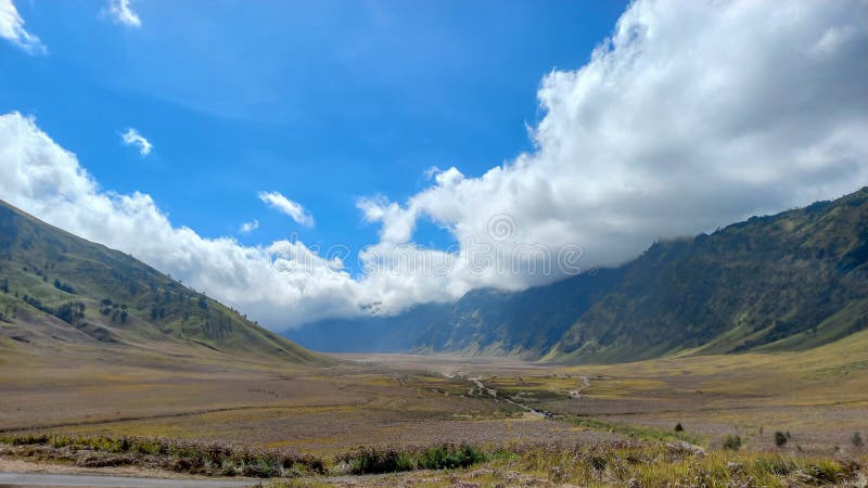 Landscape of a Wide Valley Surrounded by Towering Mountains Stock Image ...