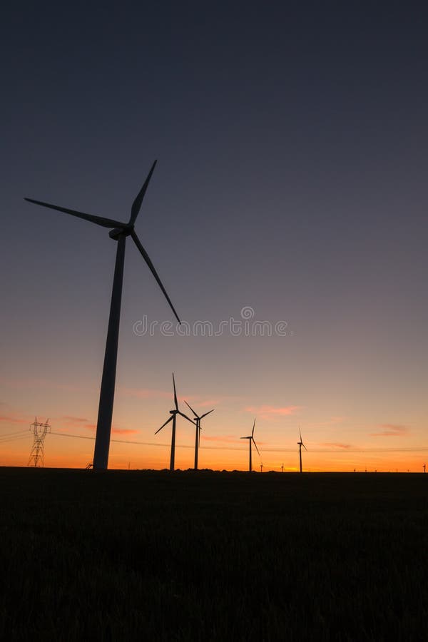 A Landscape with Windmills in a Wind Farm at Sunset Generating ...