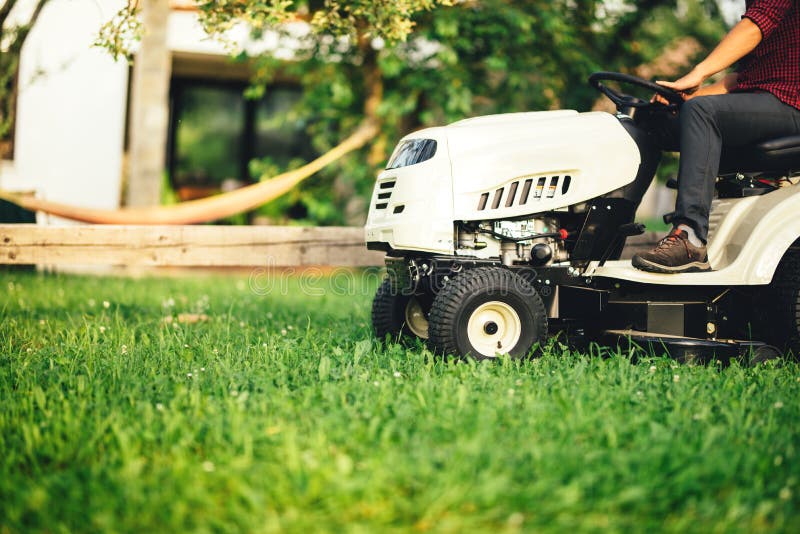 Landscaping Details - Man Using Professional Tractor for Cutting and ...