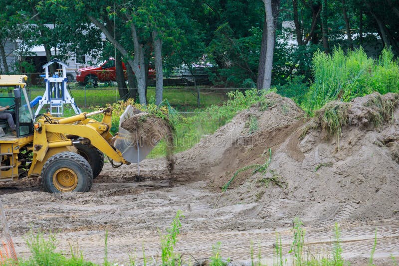 Landscaping Works on the Bulldozer Moves Soil Digging Ground ...