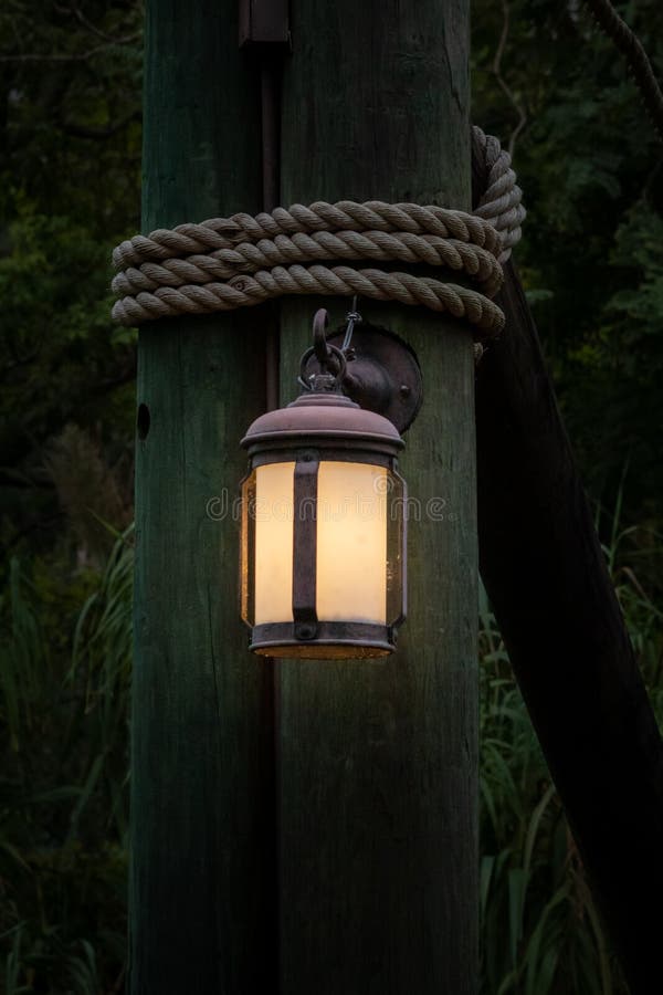 Lantern Hanging on a Pole with a Rope in a Forest Stock Photo - Image ...