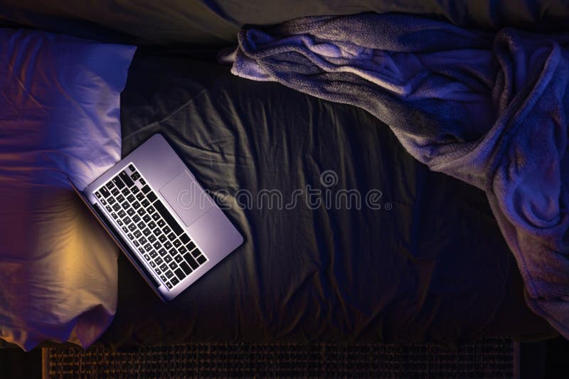 Laptop on the Bed at Night, Light from the Laptop Screen, Top View ...