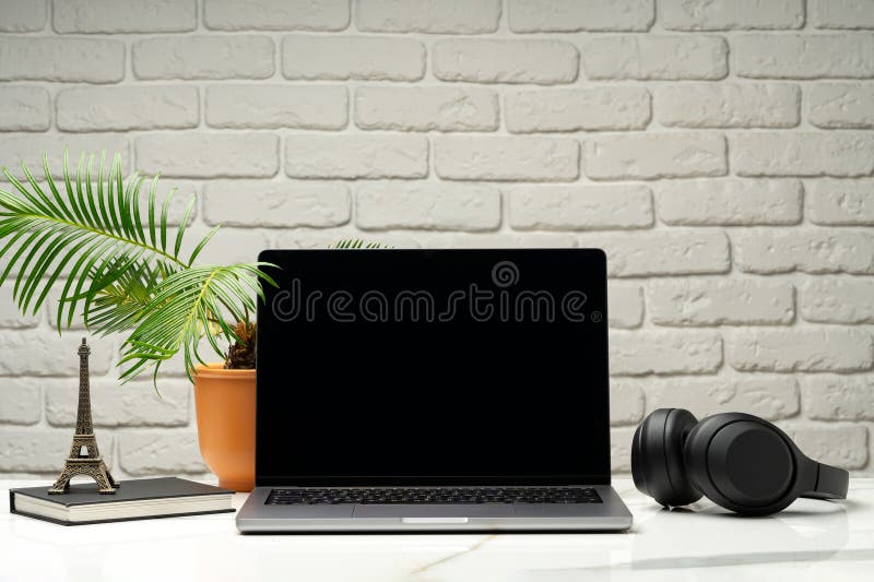 Laptop with Black Screen on Desk Against White Brick Wall Stock Image ...