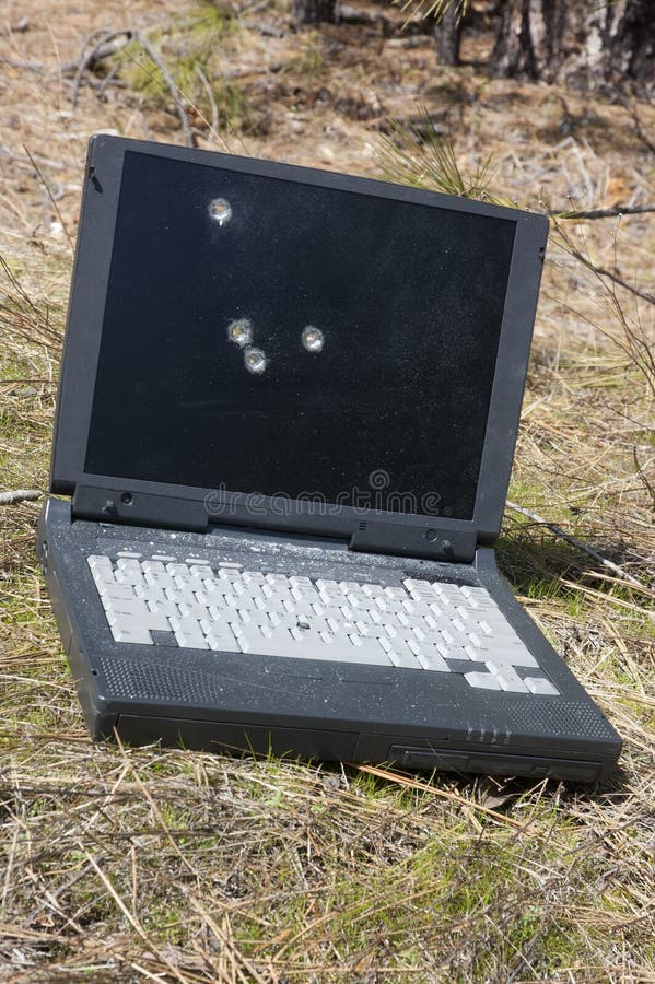 Laptop with bullet holes stock photo. Image of shot, pistol - 18928712