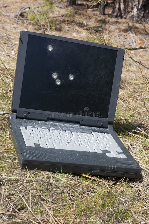 Laptop with bullet holes stock photo. Image of shot, pistol - 18928712