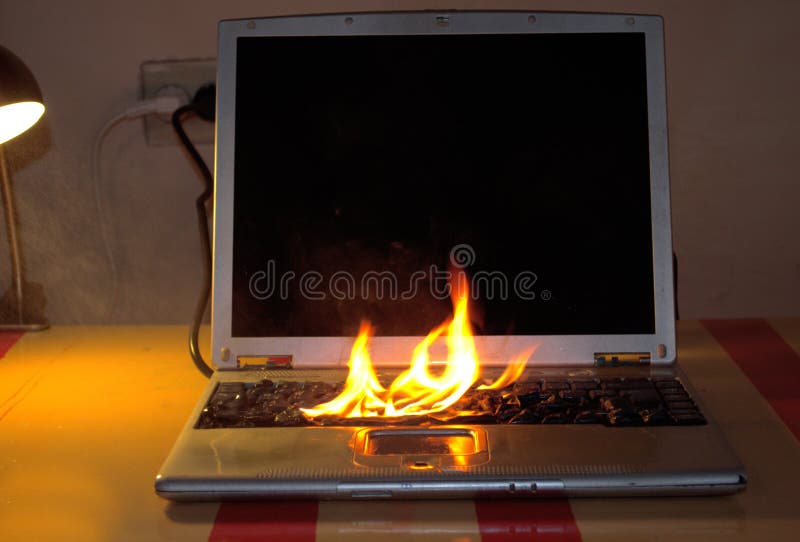 A Laptop Burns on a Table in a Room Stock Image - Image of blazing ...