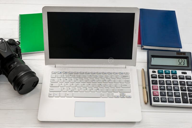 Laptop with Calculator and Digital Camera at Table Stock Image - Image ...