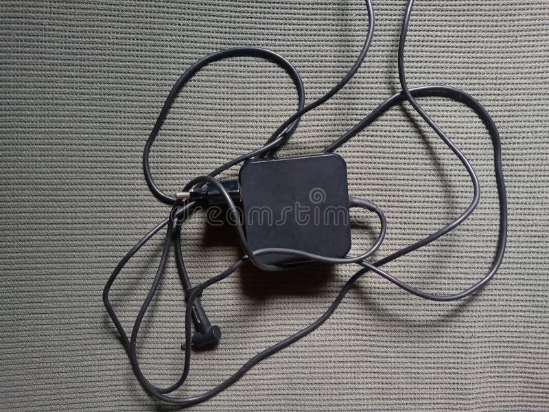 Laptop Charger with Its Messy Cable on a Structured Surface Stock Image ...