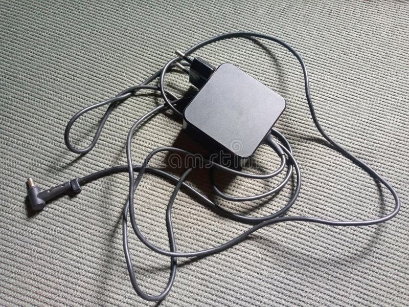 Laptop Charger with Its Messy Cable on a Structured Surface Stock Image ...