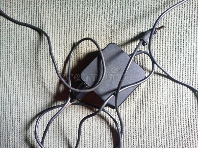 Laptop Charger with Its Messy Cable on a Structured Surface Stock Image ...