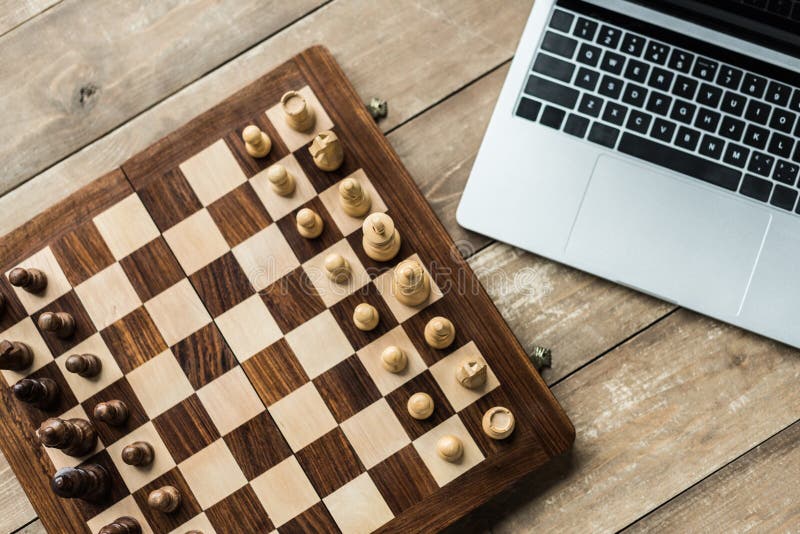 Laptop and Chess Board with Figures on Rustic Stock Image - Image of ...