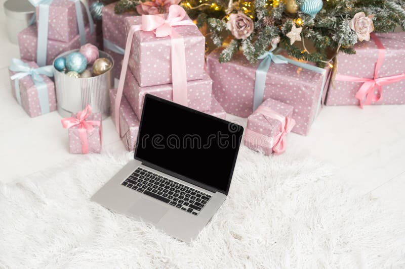 Laptop and Christmas Tree in the Background Stock Photo - Image of ...