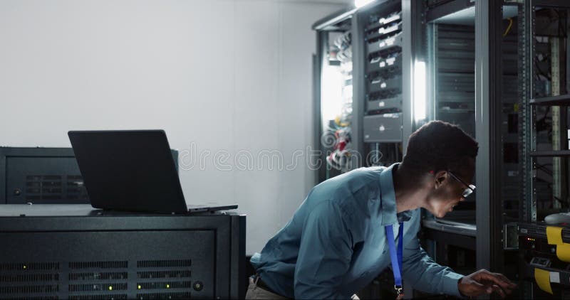 Laptop Coding And Man Engineer In Server Room For Software Cybersecurity Or Programming