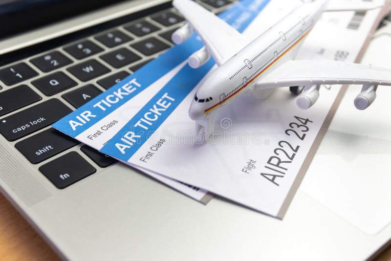 Laptop Computer and Airplane and Money on Table. Online Ticket Booking ...