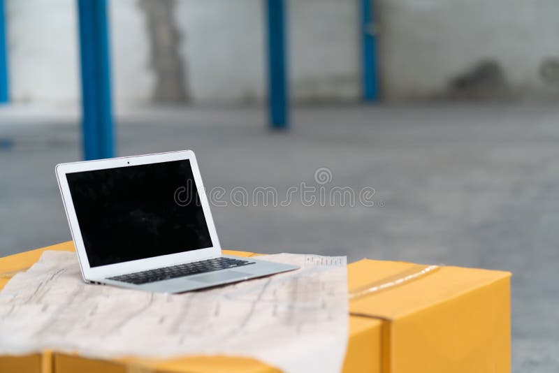 Laptop Computer and Blueprint Plan for Building Warehouse Stock Image ...