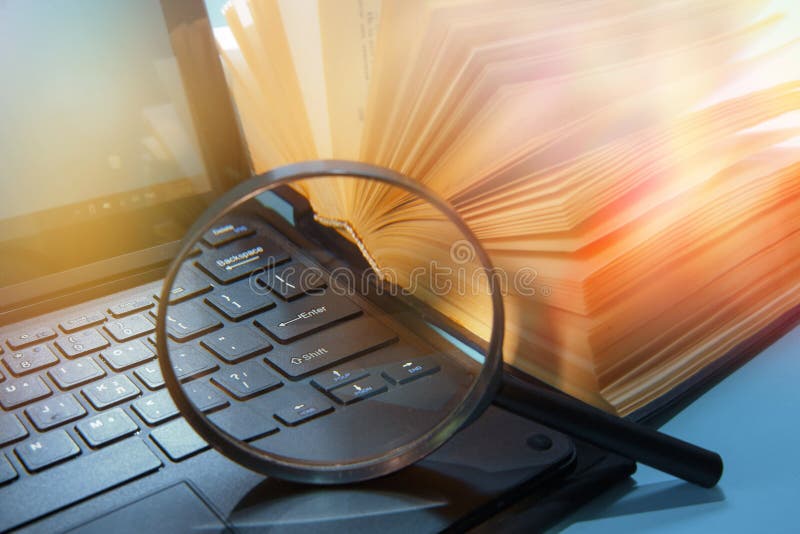 Laptop Computer and Book with Magnifying Glass Stock Image - Image of ...