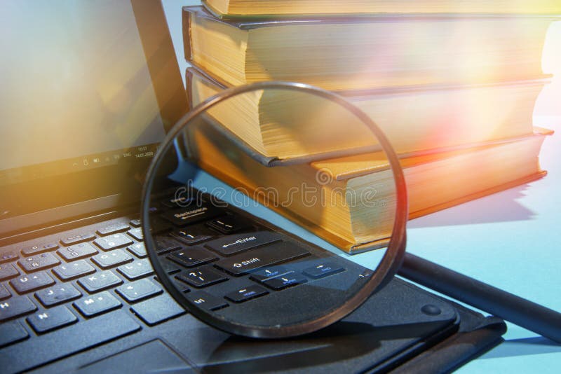 Laptop Computer and Books with Magnifying Glass Stock Photo - Image of ...
