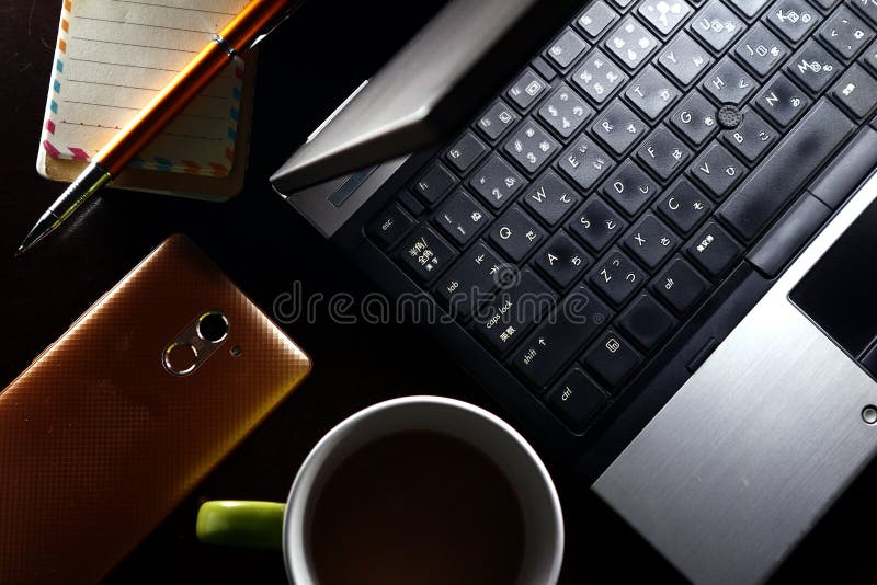 Laptop Computer, Cup of Coffee, Ballpen, Notebook and a Smartphone ...