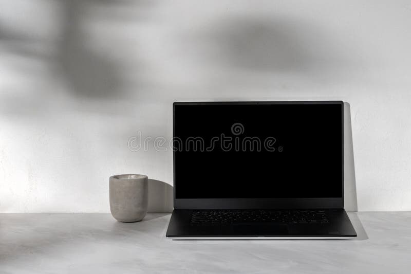 Laptop Computer with Empty Black Screen Mockup and Candle on Marble ...