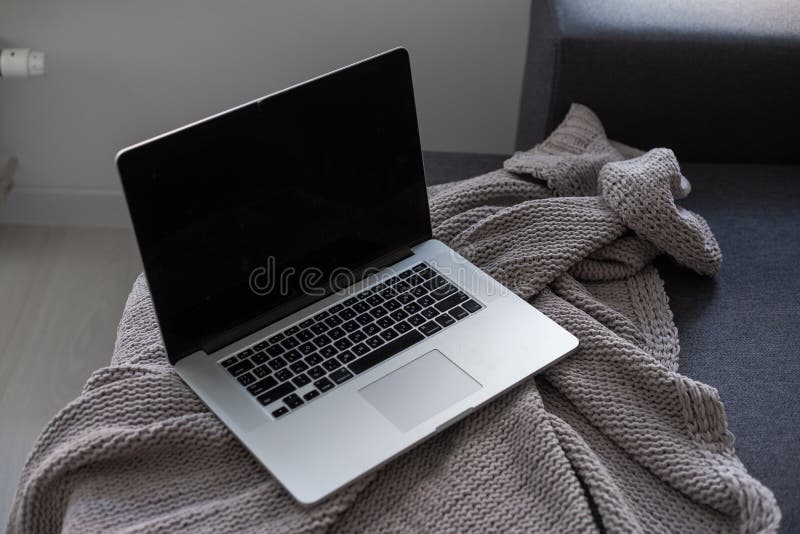 Laptop Computer on Grey Sofa with Blanket. Remote Work at Home Office ...