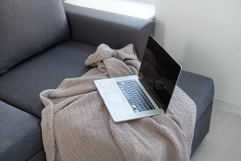 Laptop Computer on Grey Sofa with Blanket. Remote Work at Home Office ...