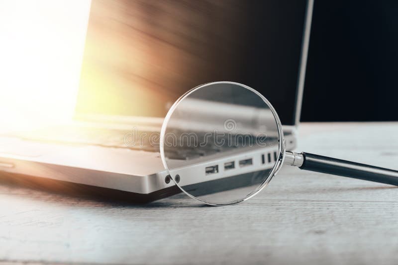 Laptop Computer with Magnifying Glass Stock Photo - Image of ...