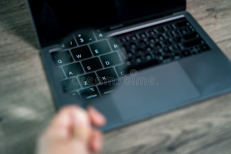 Laptop Computer with Magnifying Glass on the Laptop Keyboard, Concept ...
