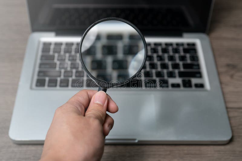 Laptop Computer with Magnifying Glass on the Laptop Keyboard, Concept ...