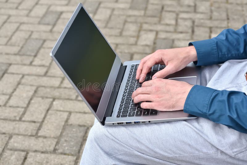 Laptop Computer and Man Hands while Working Remotely on the Computer ...
