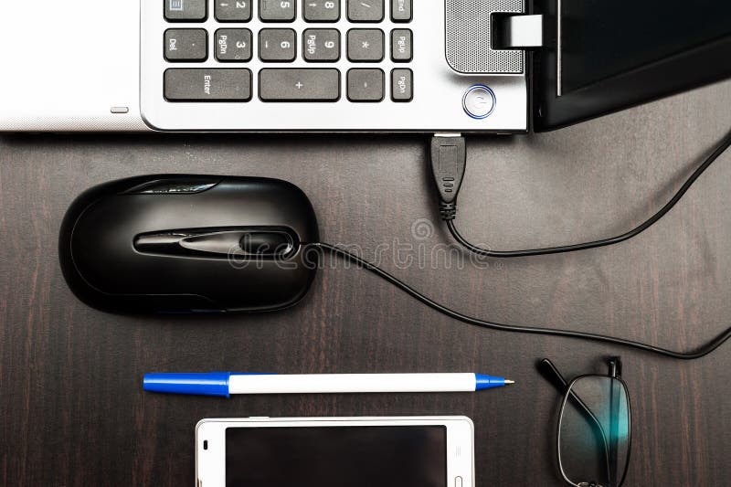 Laptop, Computer Mouse, Cell Phone, Glasses and Pen on the Table Stock ...