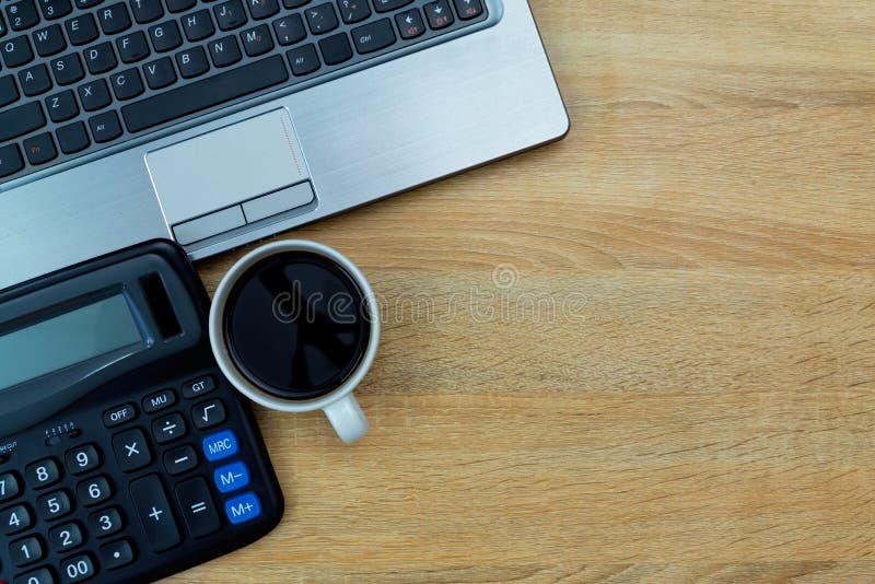 Laptop Computer or Notebook, Calculator and Cup of Coffee on Working ...