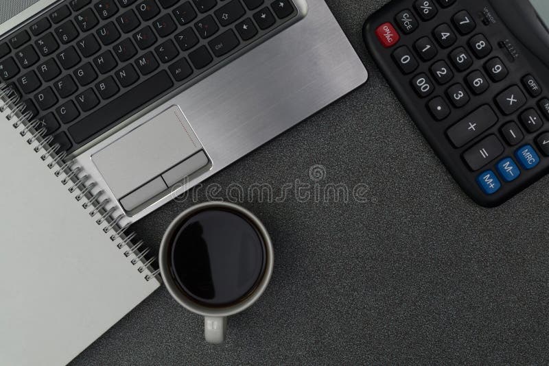 Laptop Computer or Notebook, Calculator and Cup of Coffee on Working ...