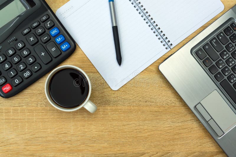 Laptop Computer or Notebook, Calculator and Cup of Coffee on Working ...
