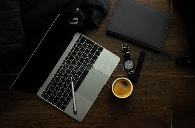 A Laptop Computer is Open on a Table with Accessories Around it ...